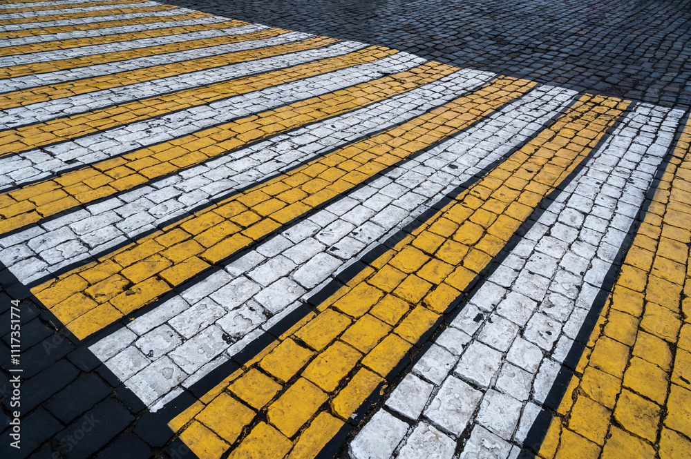 Cross walk empty. Pedestrian crossing is on paving stone. Cobblestone ...