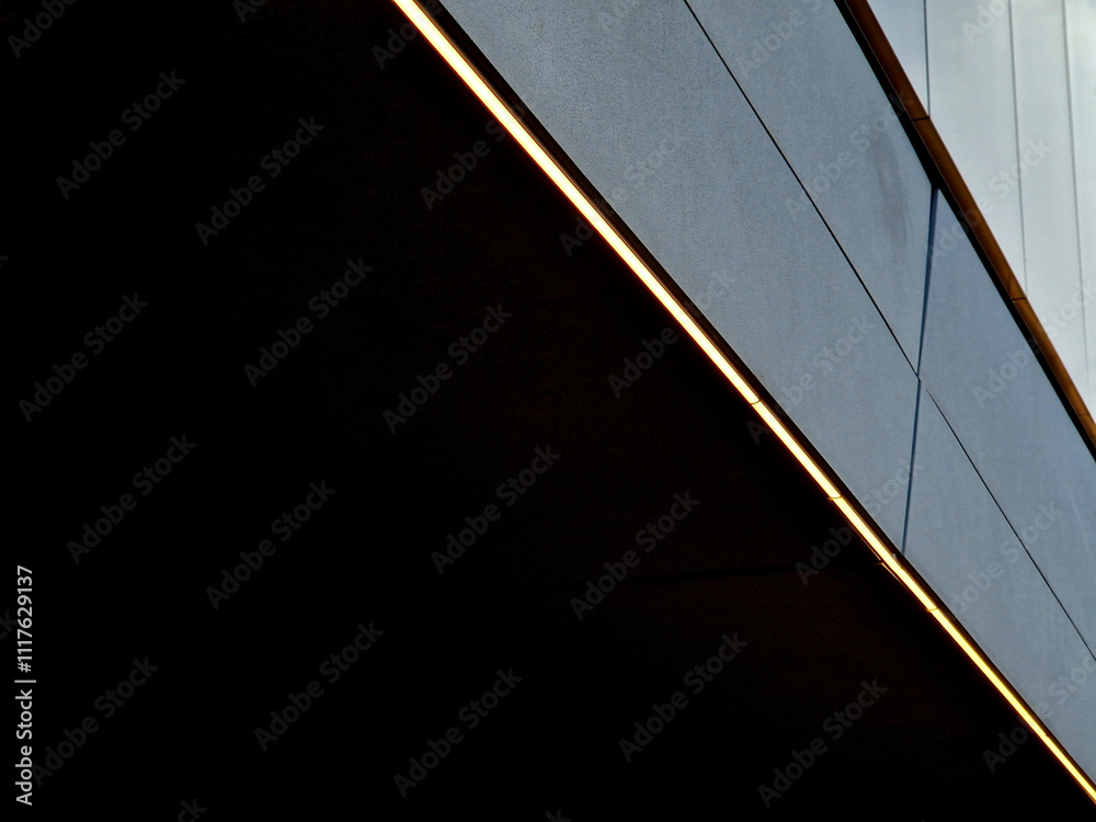 edge of the building above the entrance is highlighted in its austerity ...