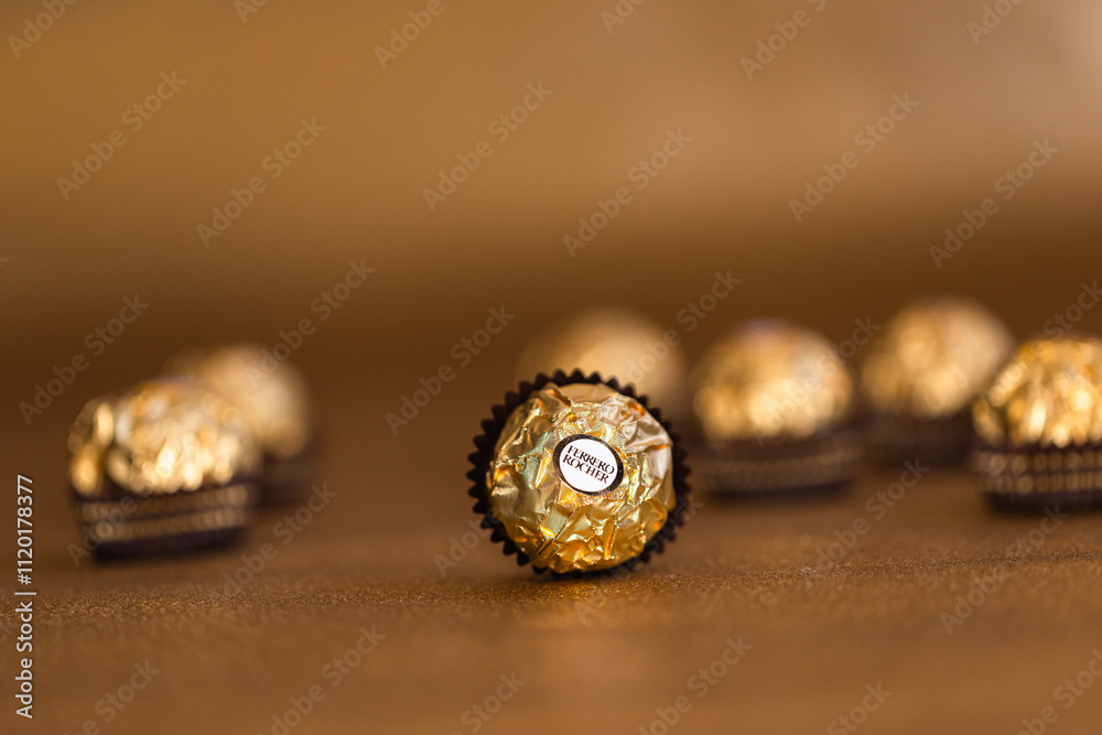 Ferrero Rocher premium chocolates on golden glitter background Stock ...