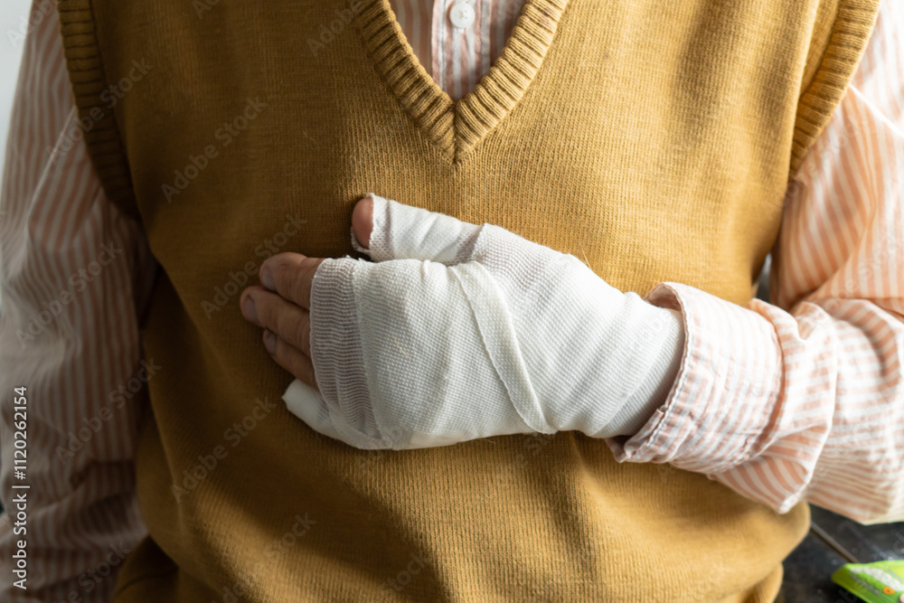 Injured patient showing doctor broken wrist and arm with bandage in ...