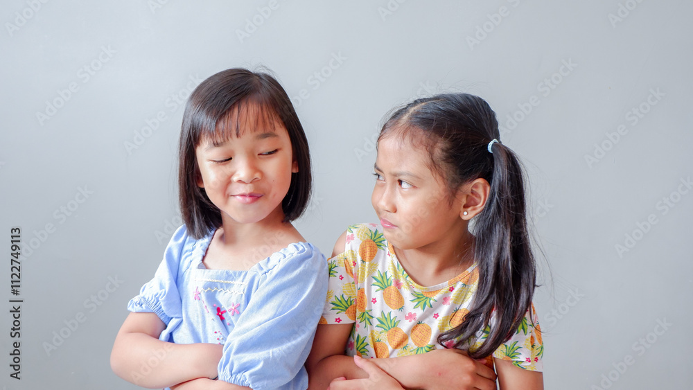 Two girls looking at each other with playful and amused expressions ...