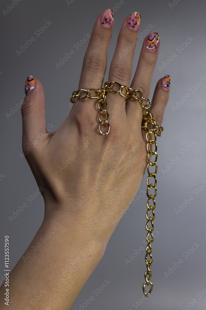Artistic photography of a female beautiful hand, gold jewelry is ...