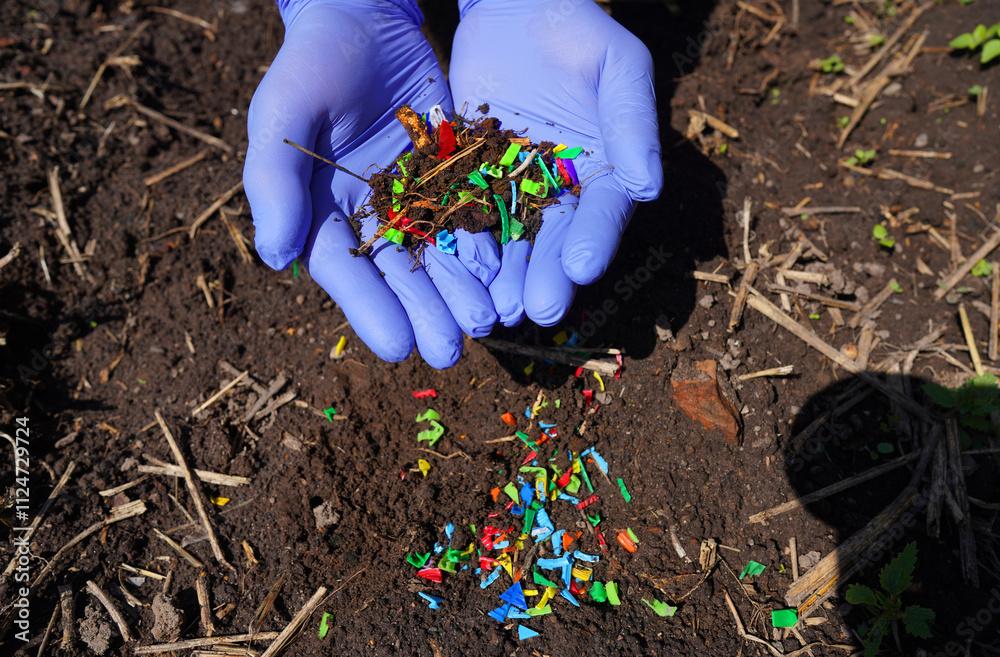 Microplastic pollution. Hand in glove with Plastic waste from soil ...
