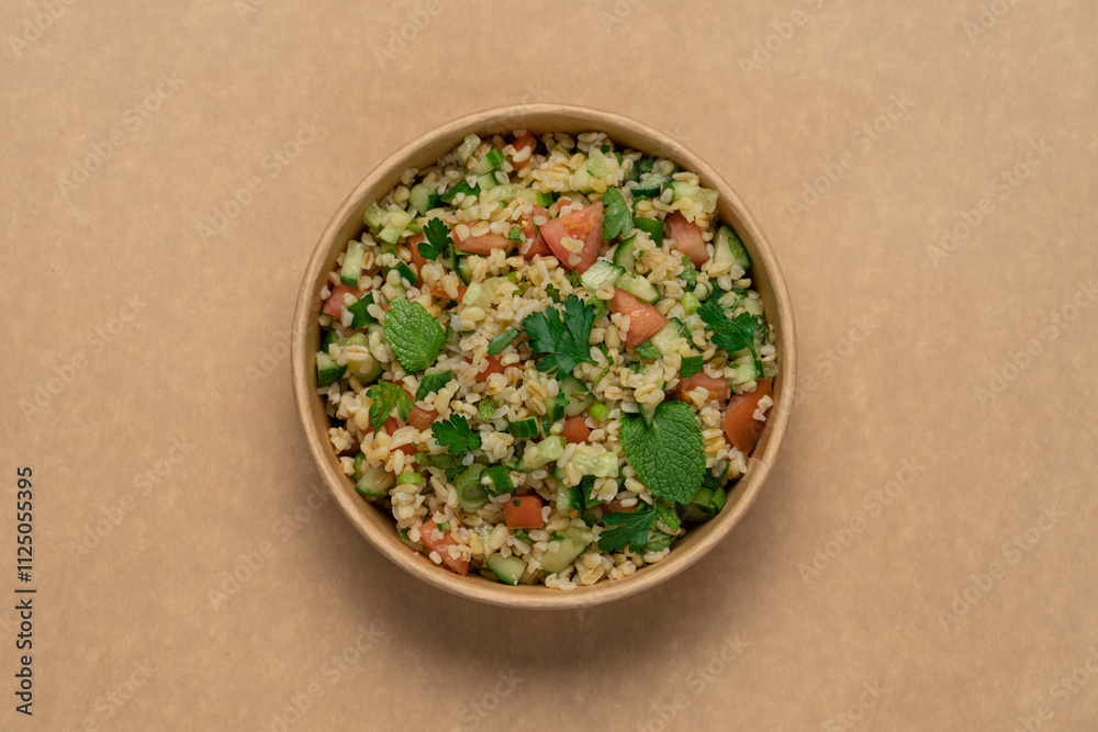 Bulgur tabbouleh salad with parsley, mint, cucumber, tomato in round ...