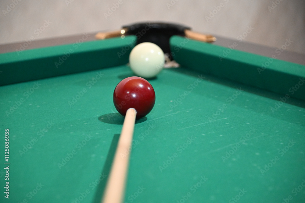 The process of playing billiards with a cue in hand at the billiard ...