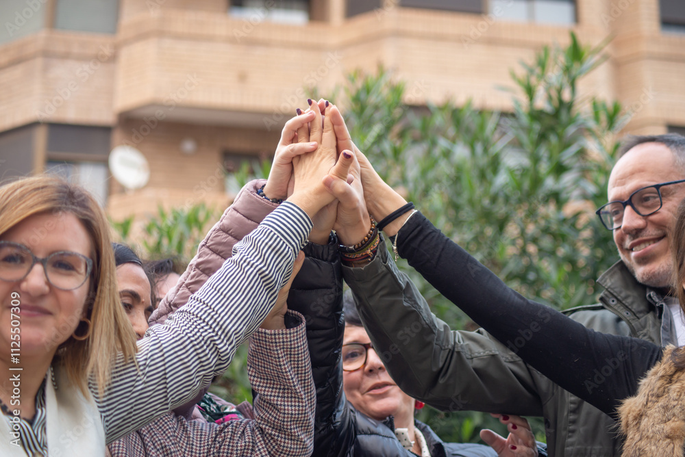Group of people putting their hands together as a symbol of unity ...