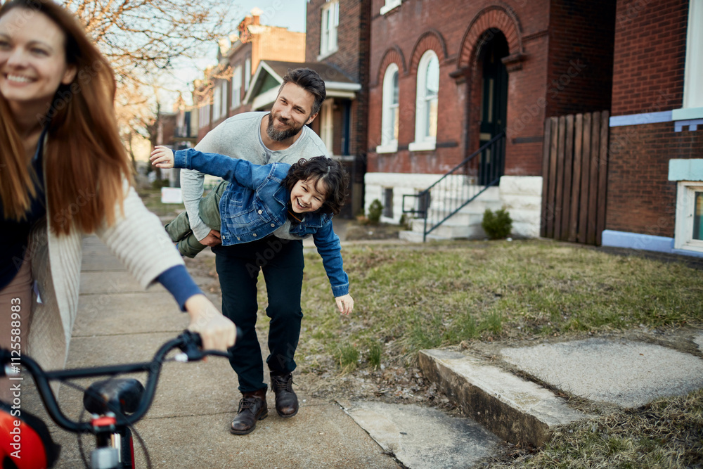 Young family having a walk through the suburbs Stock Photo | Adobe Stock