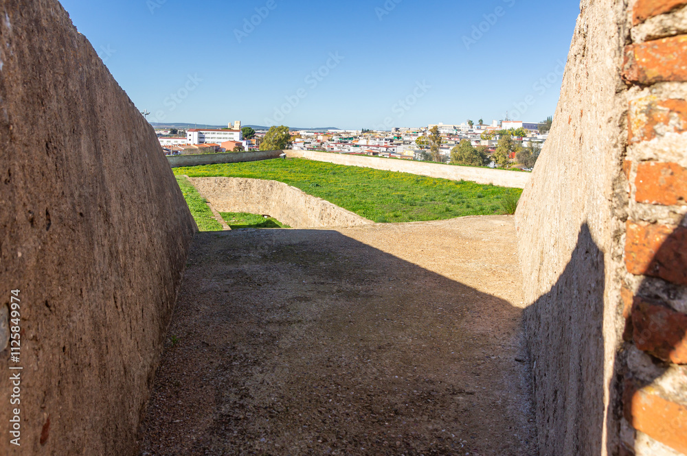 Cannon embrasure in a 17th-century fort, with a view of the moat and ...