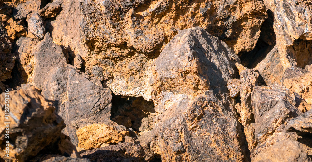 Lava formations, stones, black basalt in the rocks closeup on a volcano ...