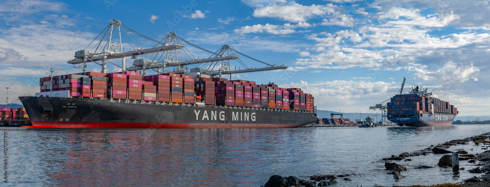Two large cargo ships docked at the Port of Oakland, loaded with ...