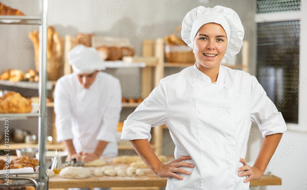 Girl works as baker in bakery, makes bakery products from dough. Worker ...