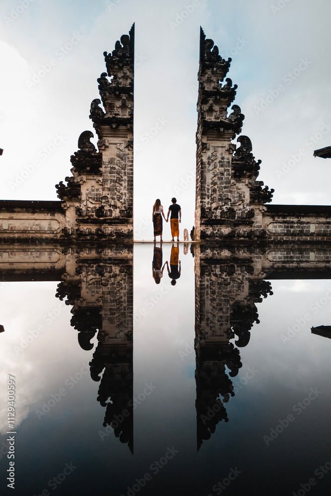 Young couple poses with their backs to the camera at the Lempuyang ...