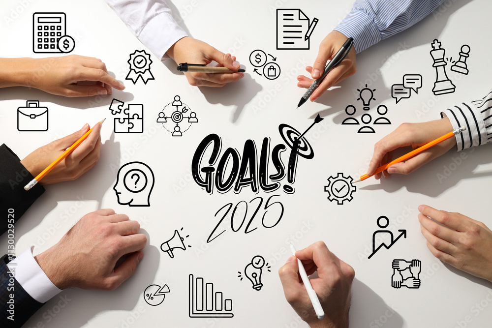 Goals 2025, hands of colleagues on a light office table, planning ...
