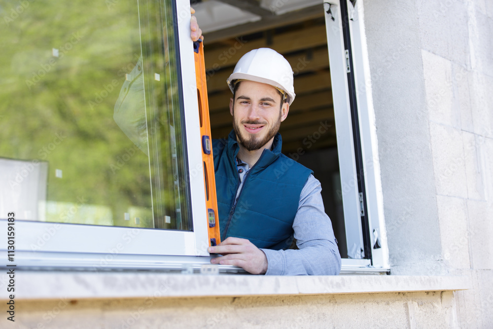 man verifying measurements using a spirit level Stock Photo | Adobe Stock