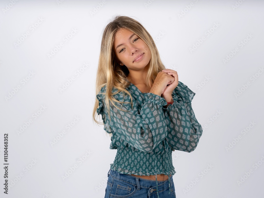 Charming serious MODEL keeps hands near face smiles tenderly at camera ...