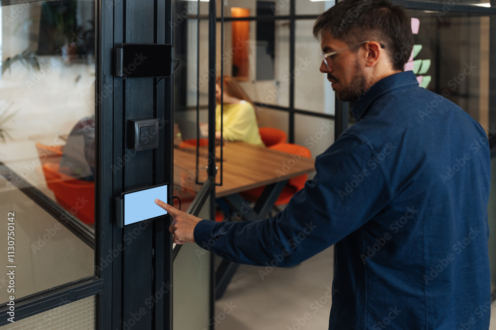 Office worker using touchscreen panel for access control in modern ...