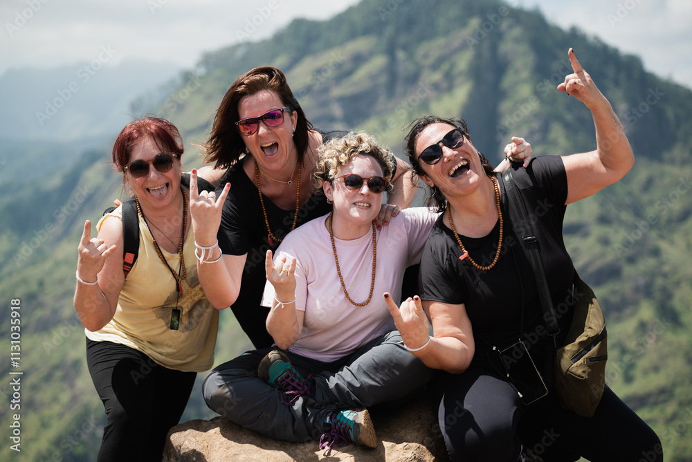 Four happy tourists doing rock and roll hand sign in sri lanka ...