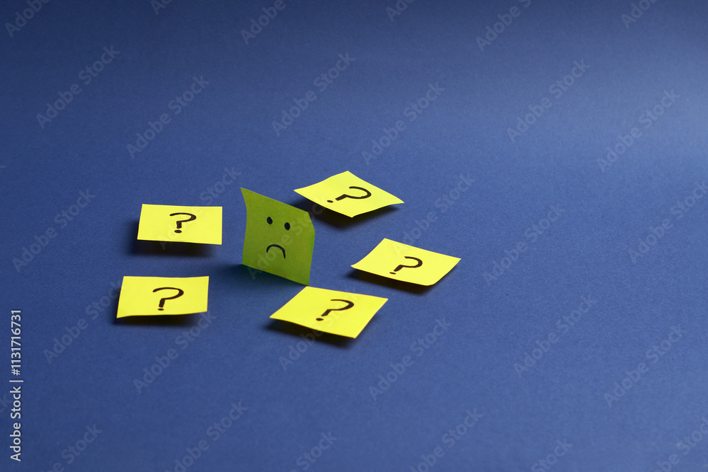 Sad face surrounded by question marks represents inner doubts ...