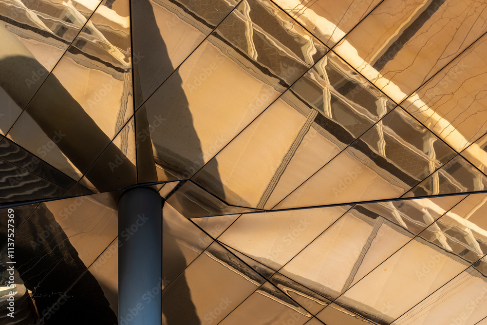 An abstract image of curved reflective surfaces of architecture ...