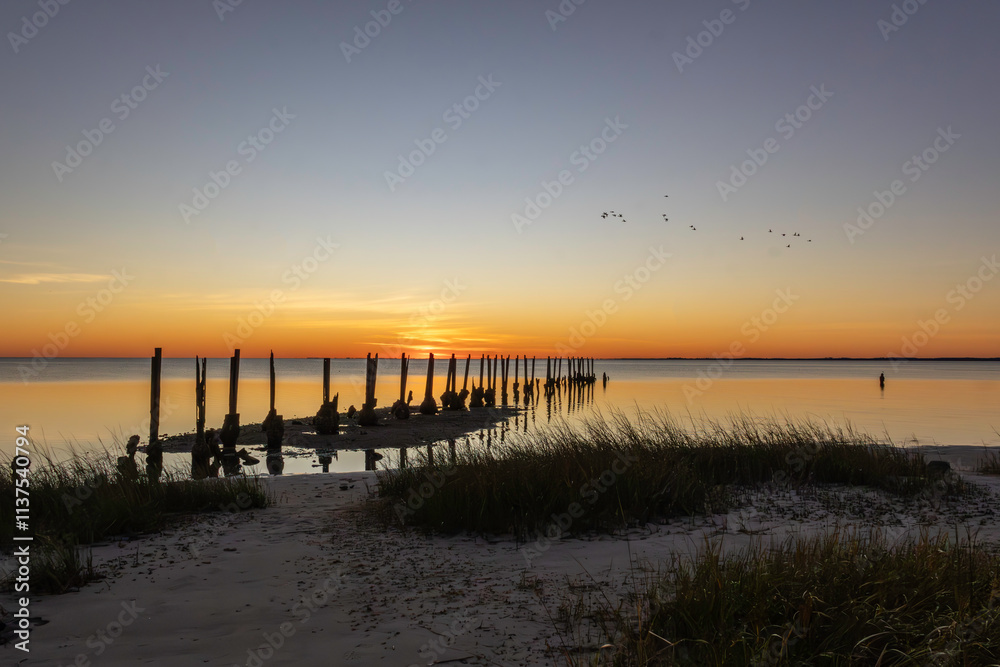 Various stages of the sunset as seen from the beach area near the St ...