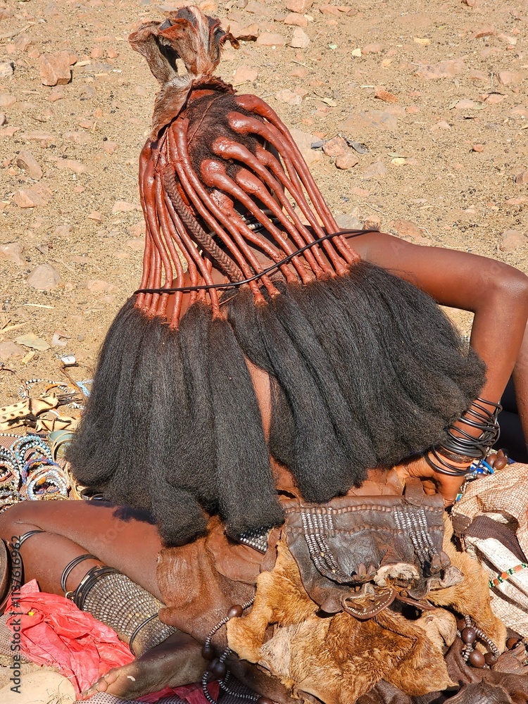Himba woman lying on the ground showing her elaborate ochre and hair ...