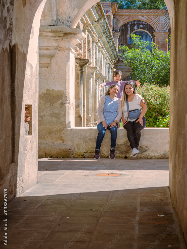 3 generations of women from a Latin family posing in front of the ...