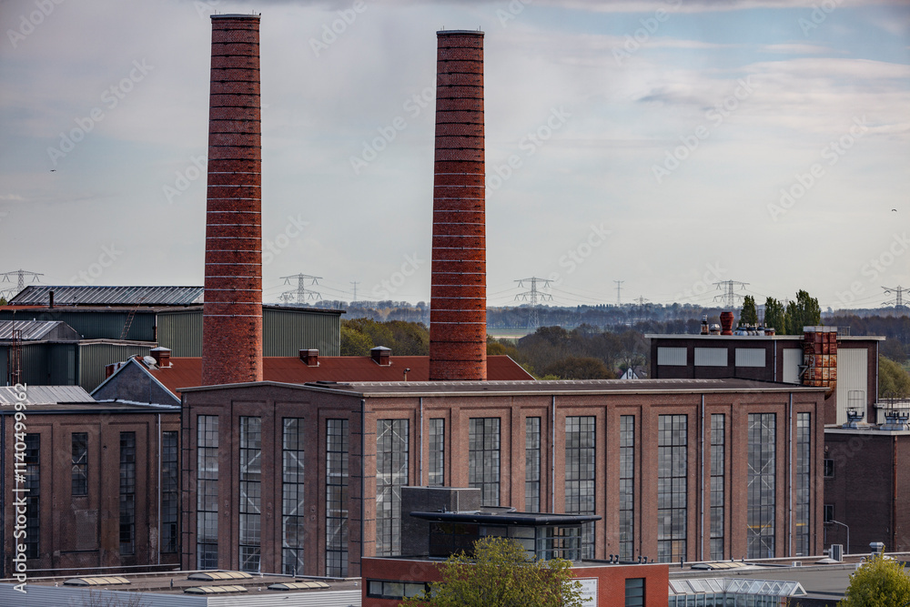 Industrial complex with large brick buildings, tall red brick chimneys ...