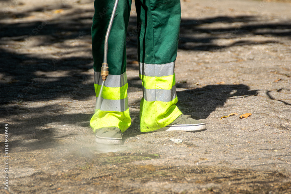 legs of a public cleaner working with a water compressor, background ...