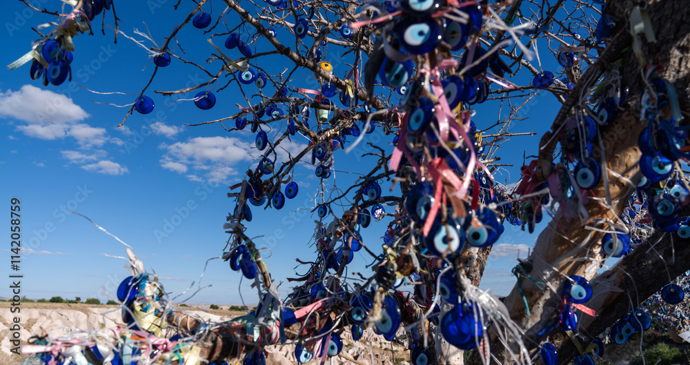 A tree adorned with vibrant Nazar amulets, also known as the Evil Eye ...