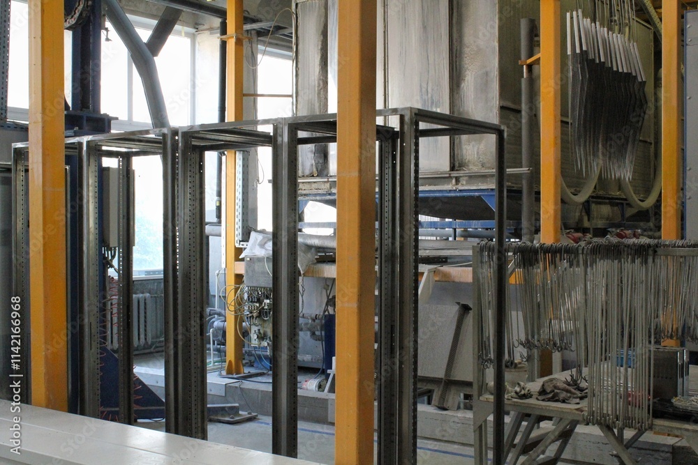 Large metal racks and tools in industrial workspace. Industrial furnace ...