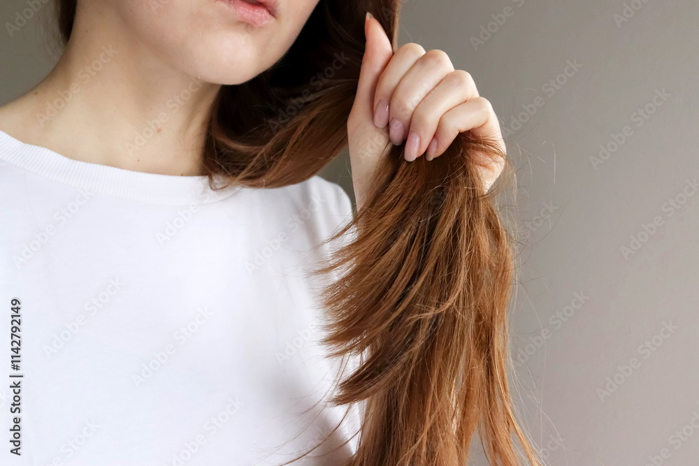 Hair health problems. Woman holding long, unhealthy hair with dry and ...