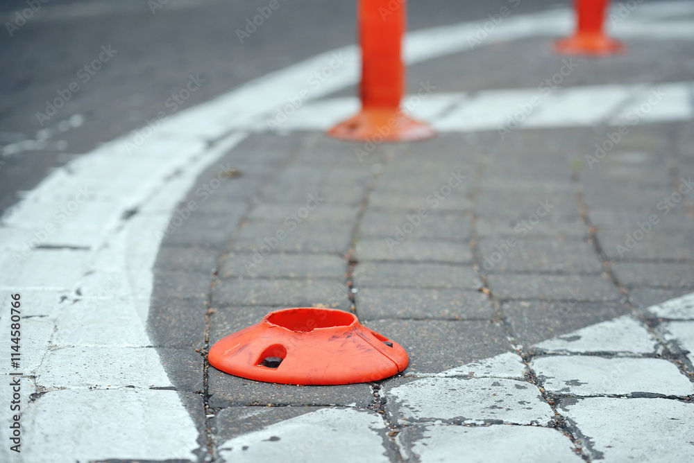 Torn off delineator closeup. Broken safety cone, damaged pylon as a ...