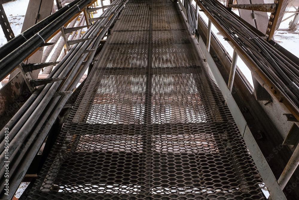 Expanded metal steel floor of busbar gallery. Сable ducts on a pass ...