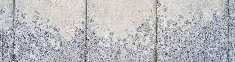 New cement sidewalk weathered and worn with aggregate rocks showing ...