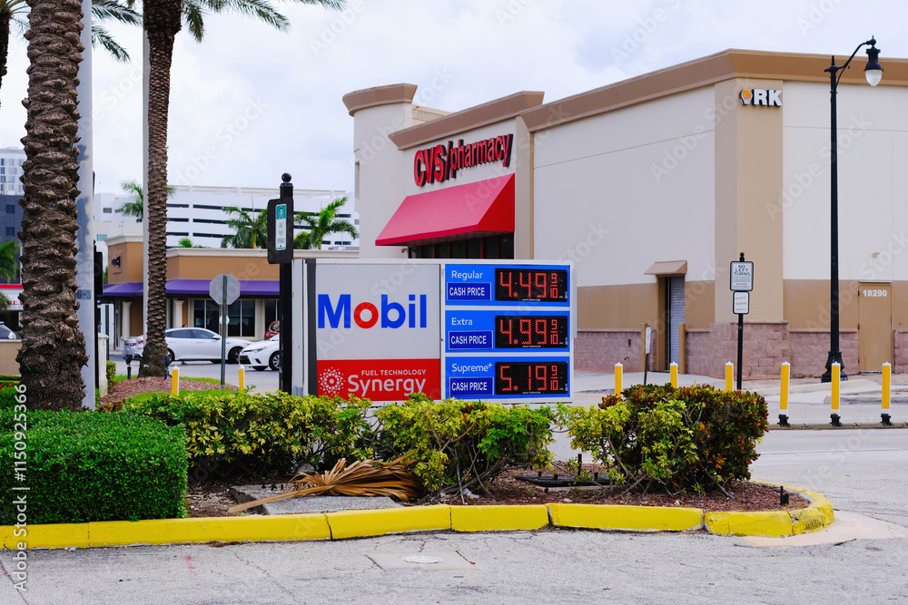 Gas station sign displays fuel prices at Mobil with a CVS Pharmacy in ...
