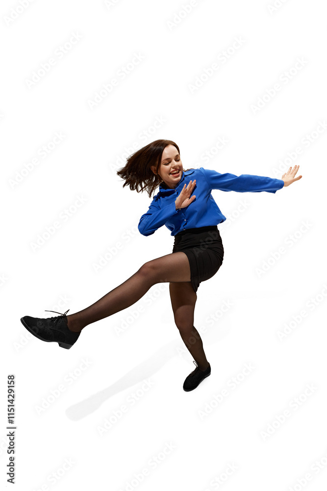 Happy young woman dancing of joy and happiness against white studio ...