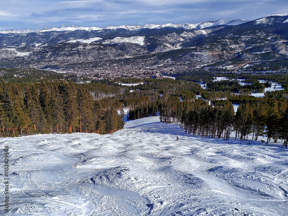 Ski resort run in the rocky mountains. Blue sky. Rocky mountain peaks ...