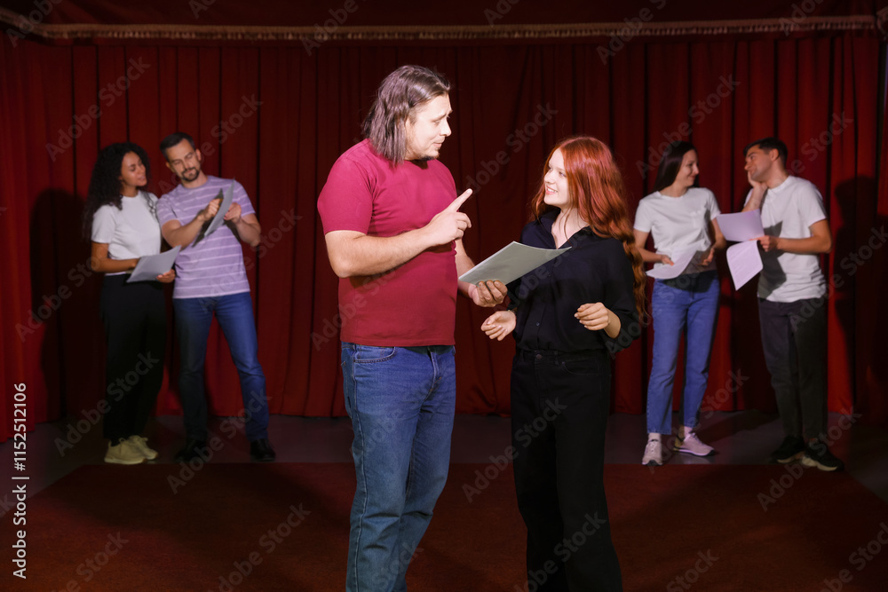 Professional actors with their scripts rehearsing in theatre Stock ...