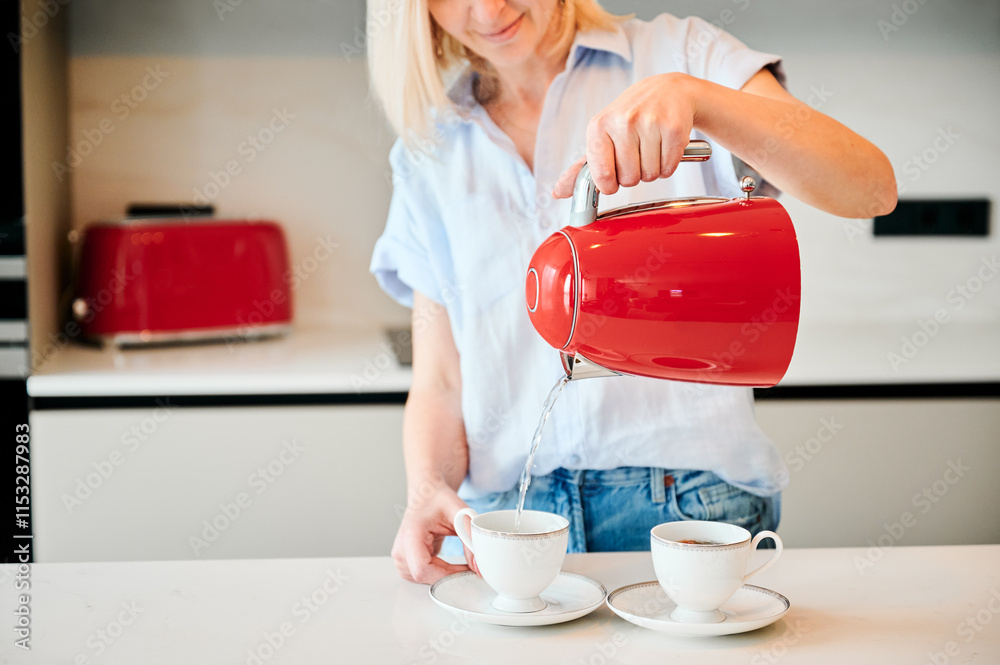 Cropped picture of woman pouring water into cup. Young female making ...