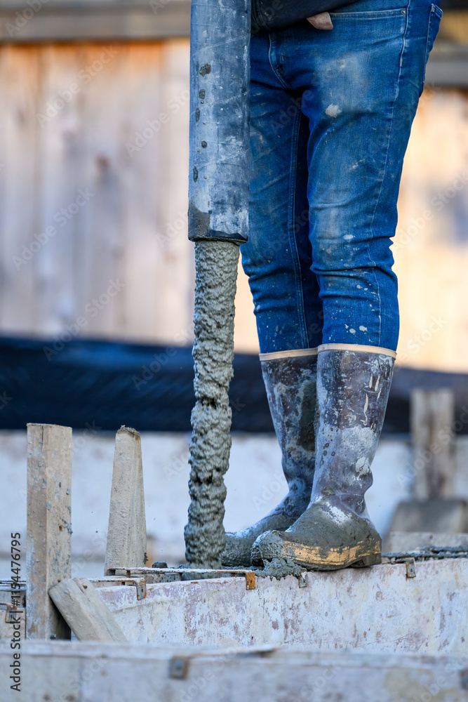 Construction worker walking on wood cement form panels for foundation ...