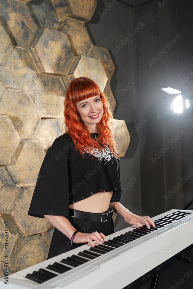 Beautiful keyboardist woman performing confidently in front of a ...