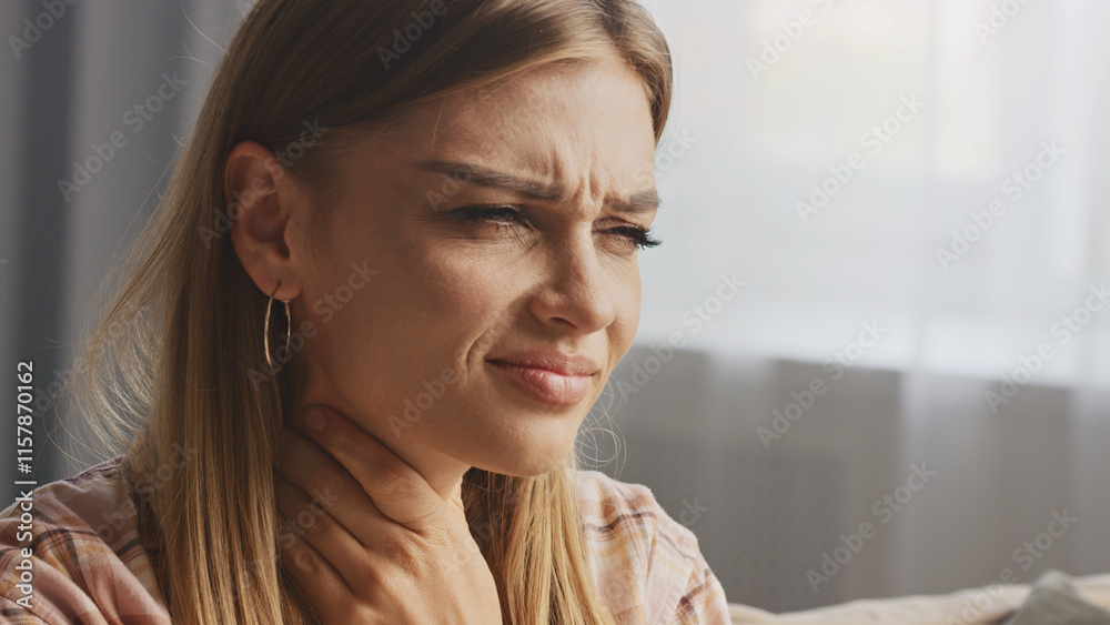 Young woman feeling unwell. Suffering from throat problems. Touching ...