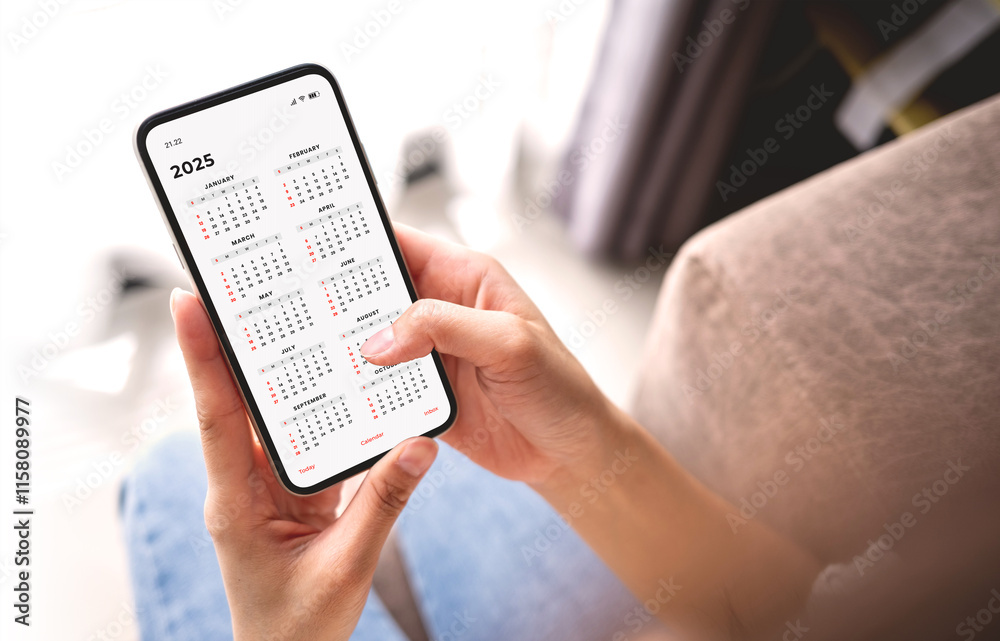 Businesswoman using smartphone with monthly calendar to plan 2025 ...