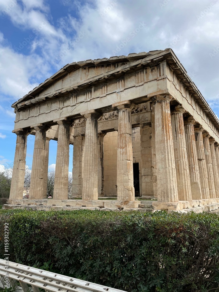 This photo depicts an ancient Greek temple with well-preserved Doric columns and a triangular ...