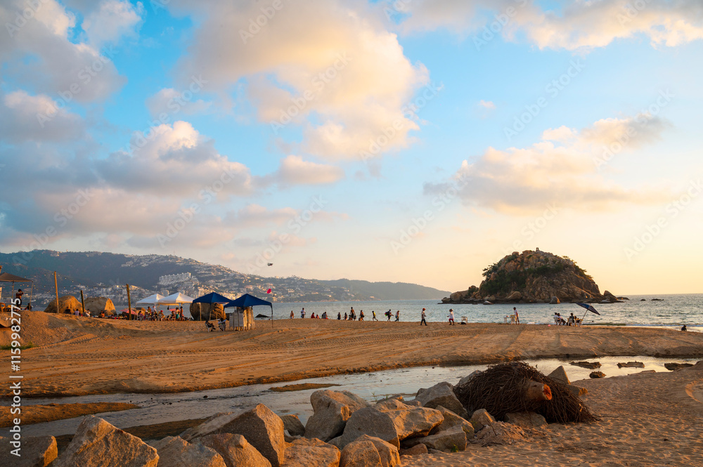 Quiet afternoon on the beach of Acapulco Bay. The sun is about to set ...