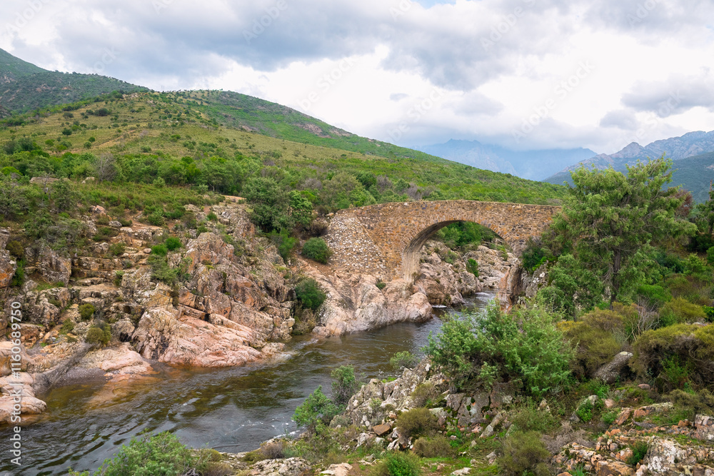 An ancient Roman stone bridge built to cross from one rocky river bank ...