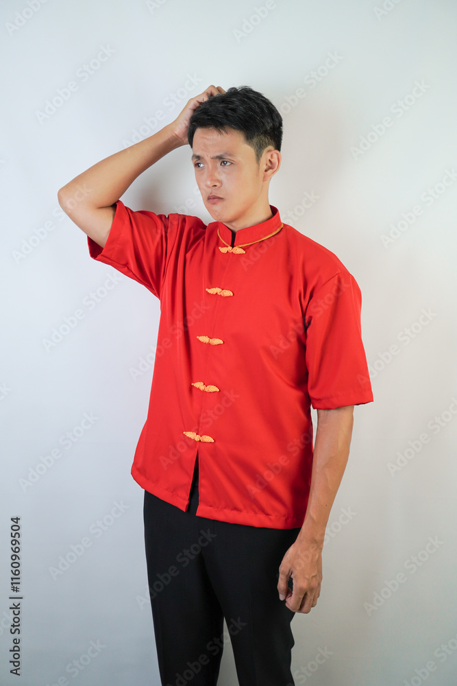 Confused young asian man wearing red traditional chinese clothing ...