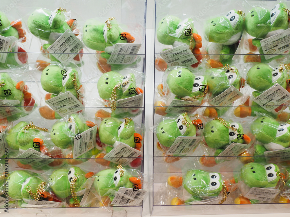 TOKYO, JAPAN - December 29, 2024: Yoshi the dinosaur soft toys in a ...