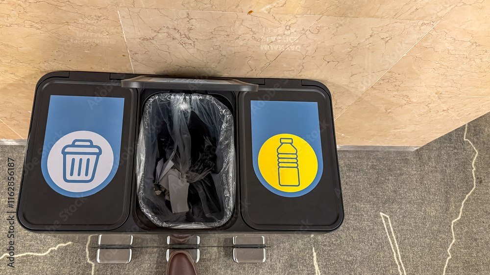 Recycling bins in an office setting demonstrate waste management ...