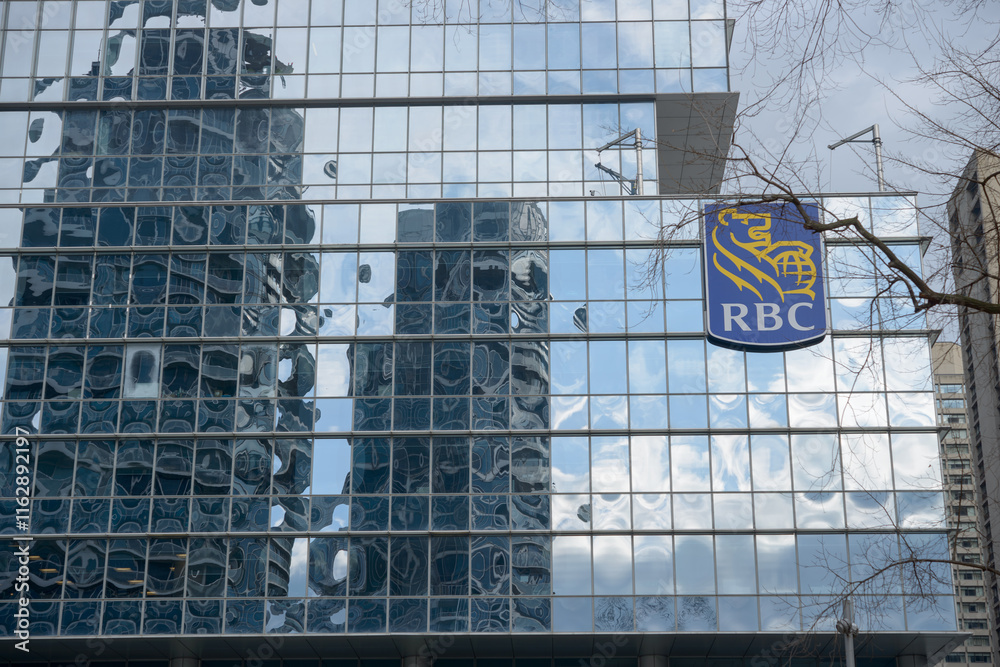 reflection of buildings and cloudy sky on west facing facade of RBC ...